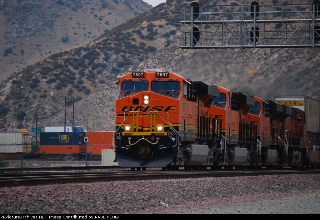 BNSF 7897 and BNSF 7896 make the curve on Main 3 as they decend towards San Bernardino, Ca with ...